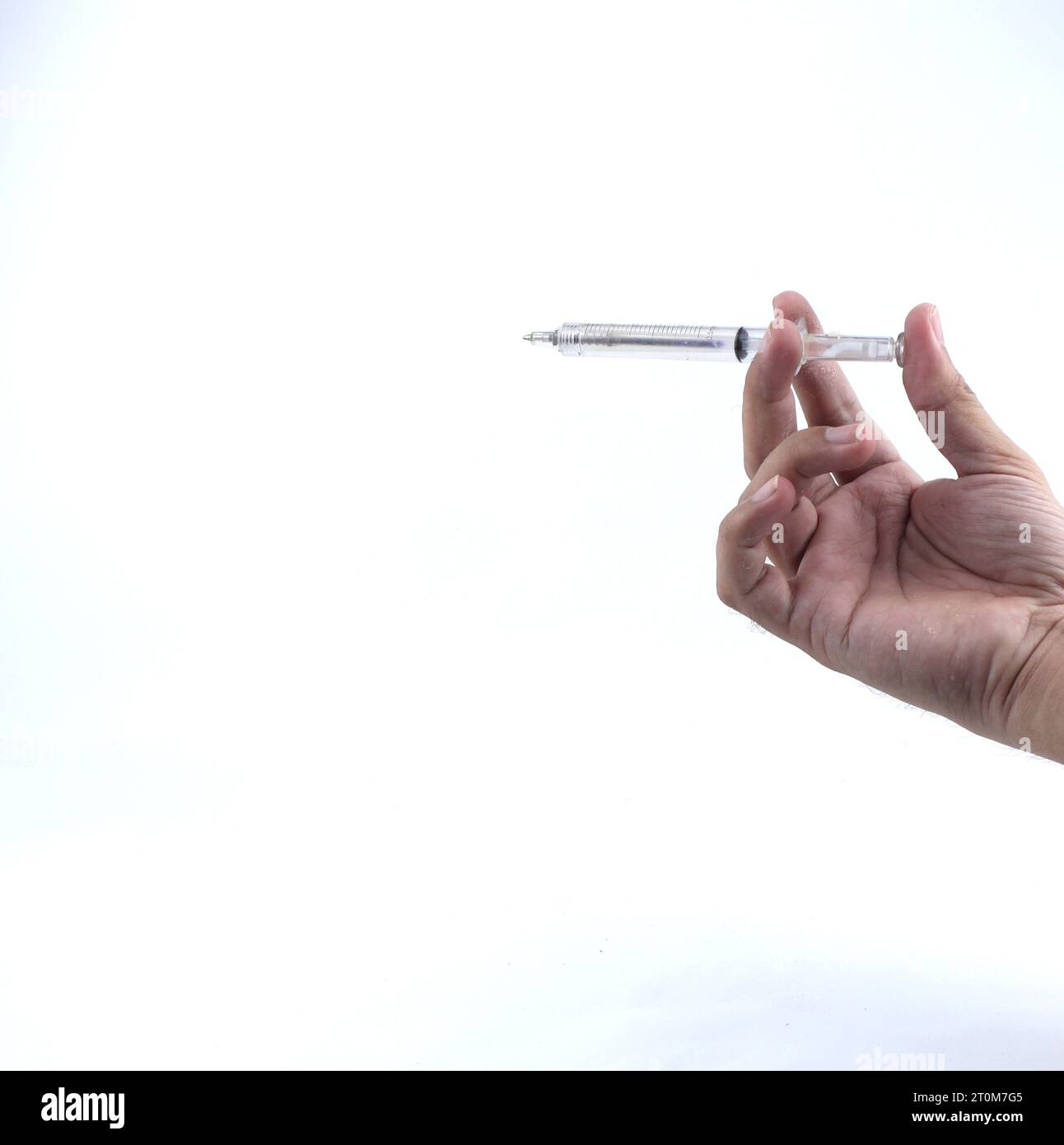 hand holding a small syringe Stock Photo - Alamy