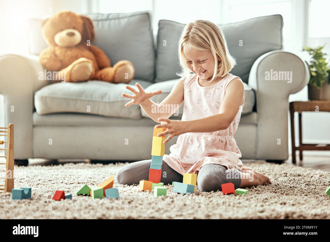 Kid, playing alone and toys on living room floor, house and educational ...