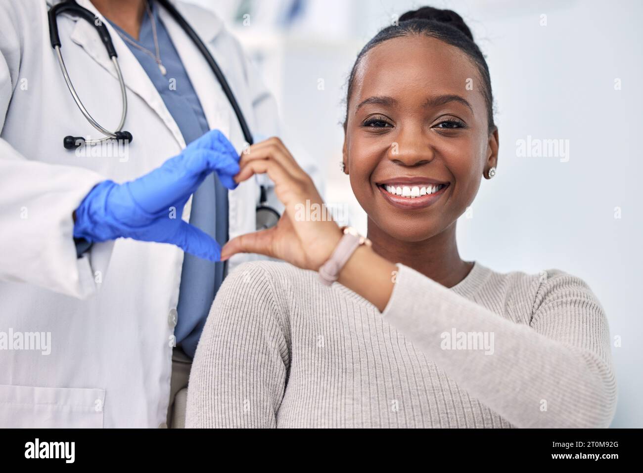 Black woman, patient and doctor with smile, consultation and heart ...