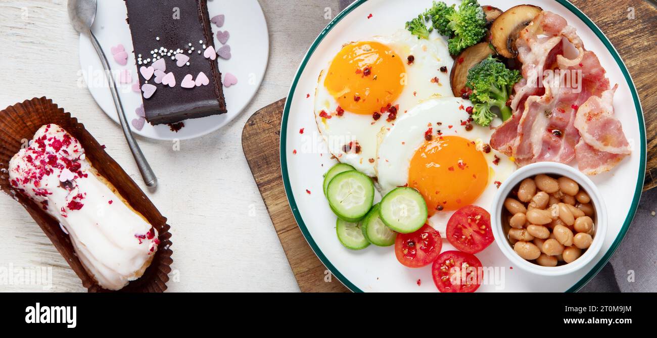 Traditional Englis breakfast plate with bacon strips, sunny side up ...