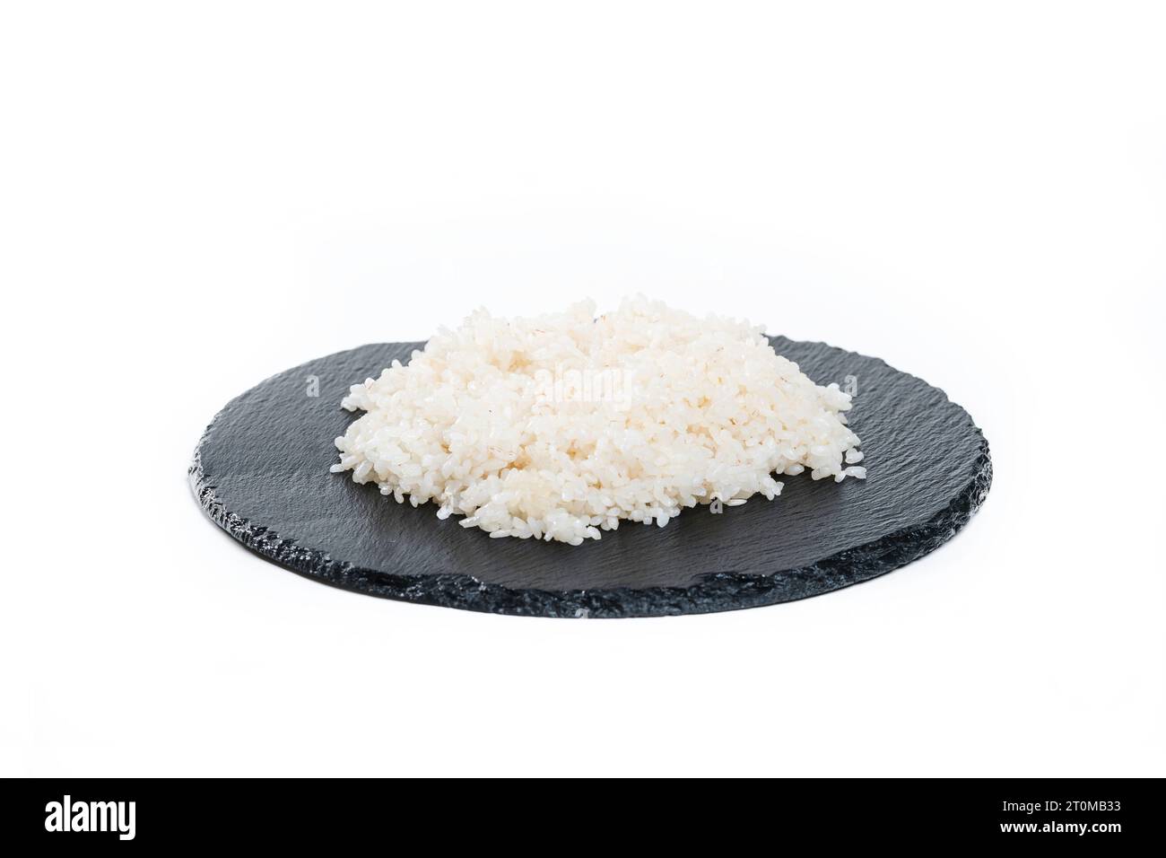 delicious isolated white rice on a black plate. View from above ...