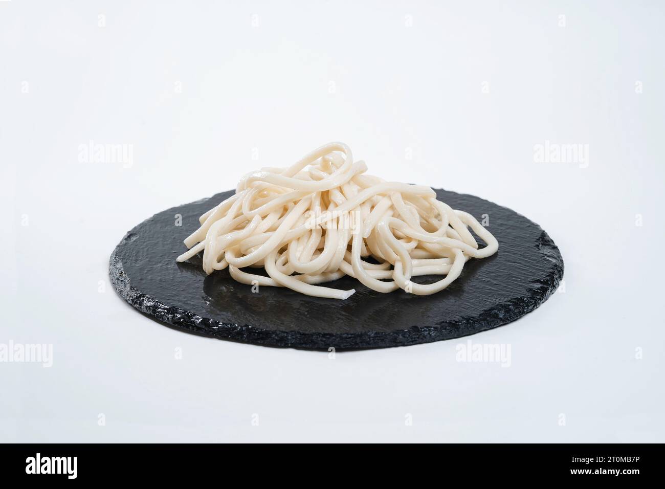 delicious noodles on a black plate. Garnish. View from above. Chinese ...
