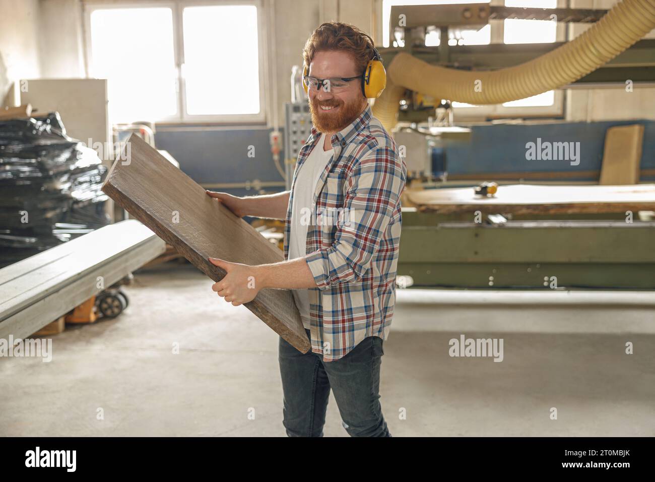 Professional male carpenter working on carpentry manufacturing with ...