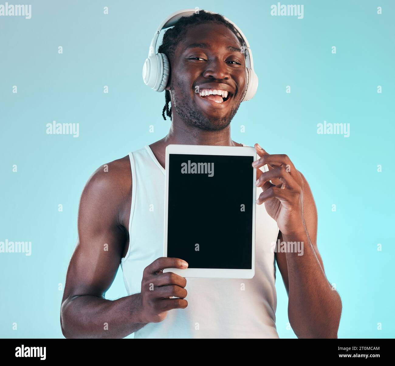 Headphones, mockup and black man with tablet screen in a studio ...