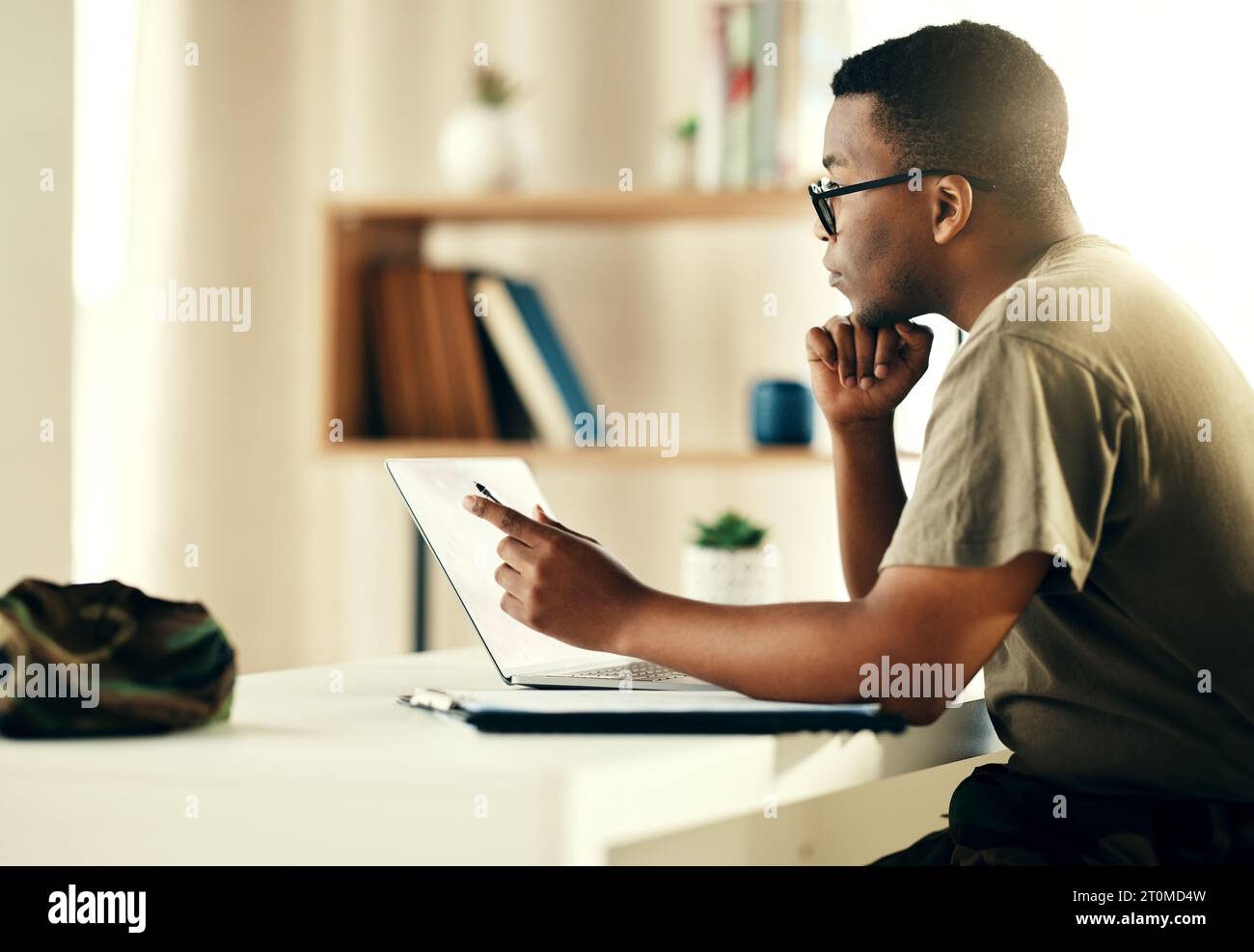 Black man, laptop and reading military information, planning or army ...