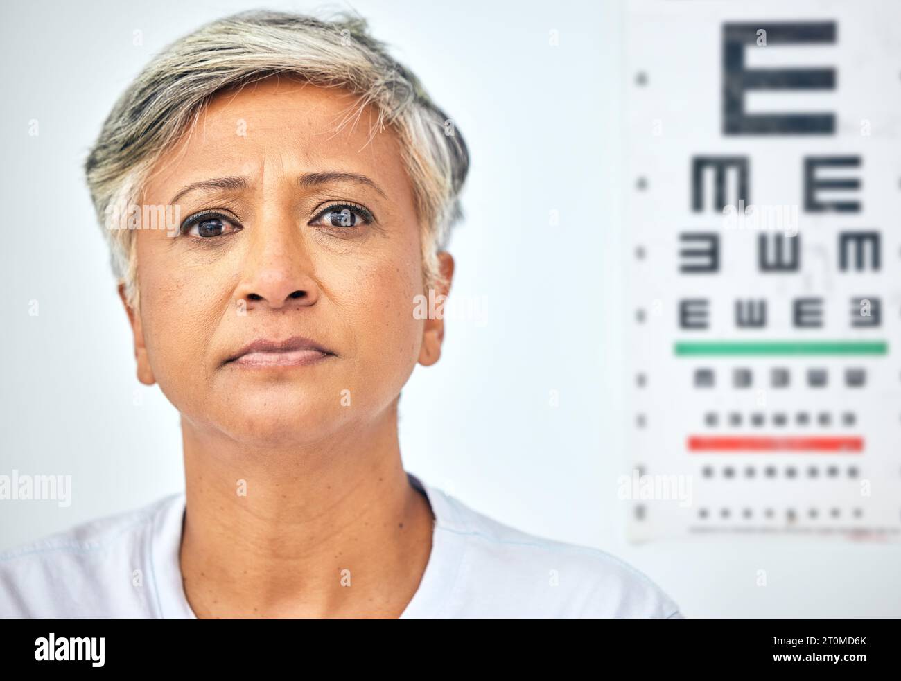 Senior woman, patient and serious portrait and vision test at ...