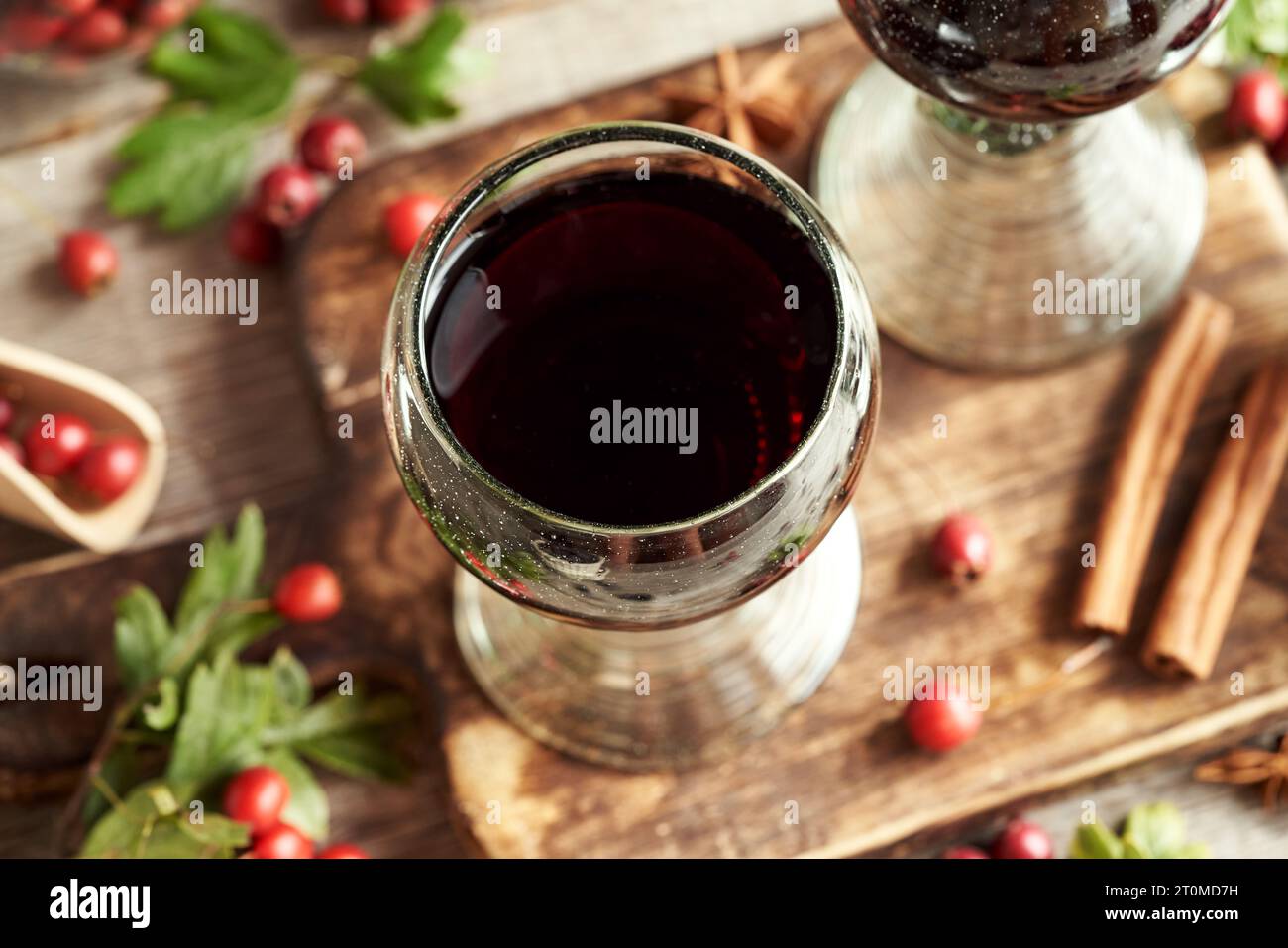 Medicinal wine made from fresh ripe hawthorn berries, in a cup made of ...