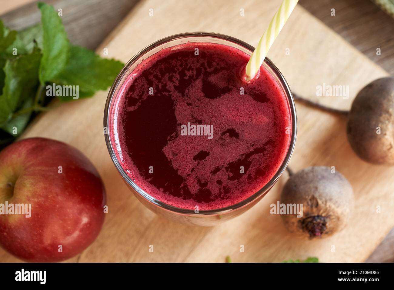 Fresh beetroot juice in a glass cup with red apples, top view Stock ...