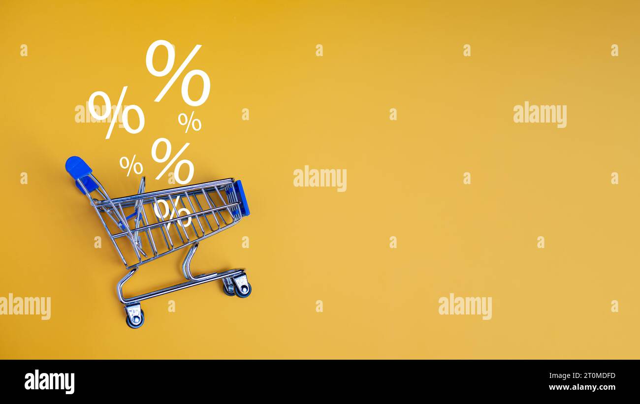 Sale percentage falling in shopping car on yellow background. Shopping ...