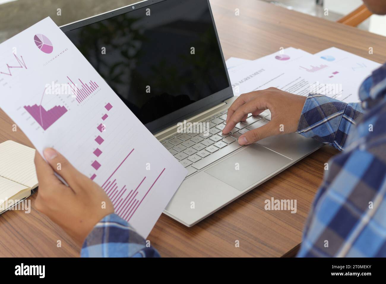 Close up of male freelance worker hand working on laptop and pointing ...