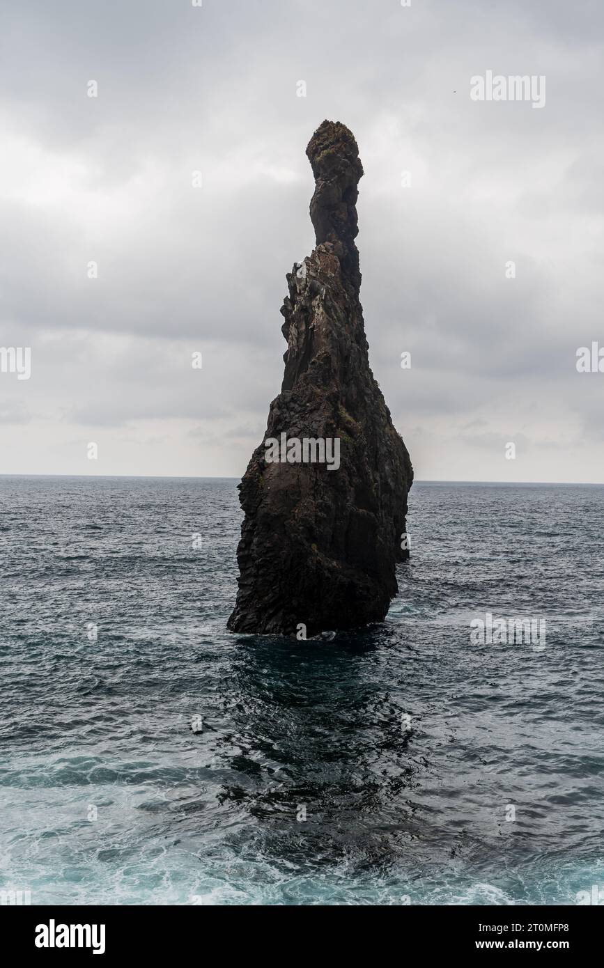 Isolated small rocky isle in wild Atlantic Ocean near Ribeira da Janela ...