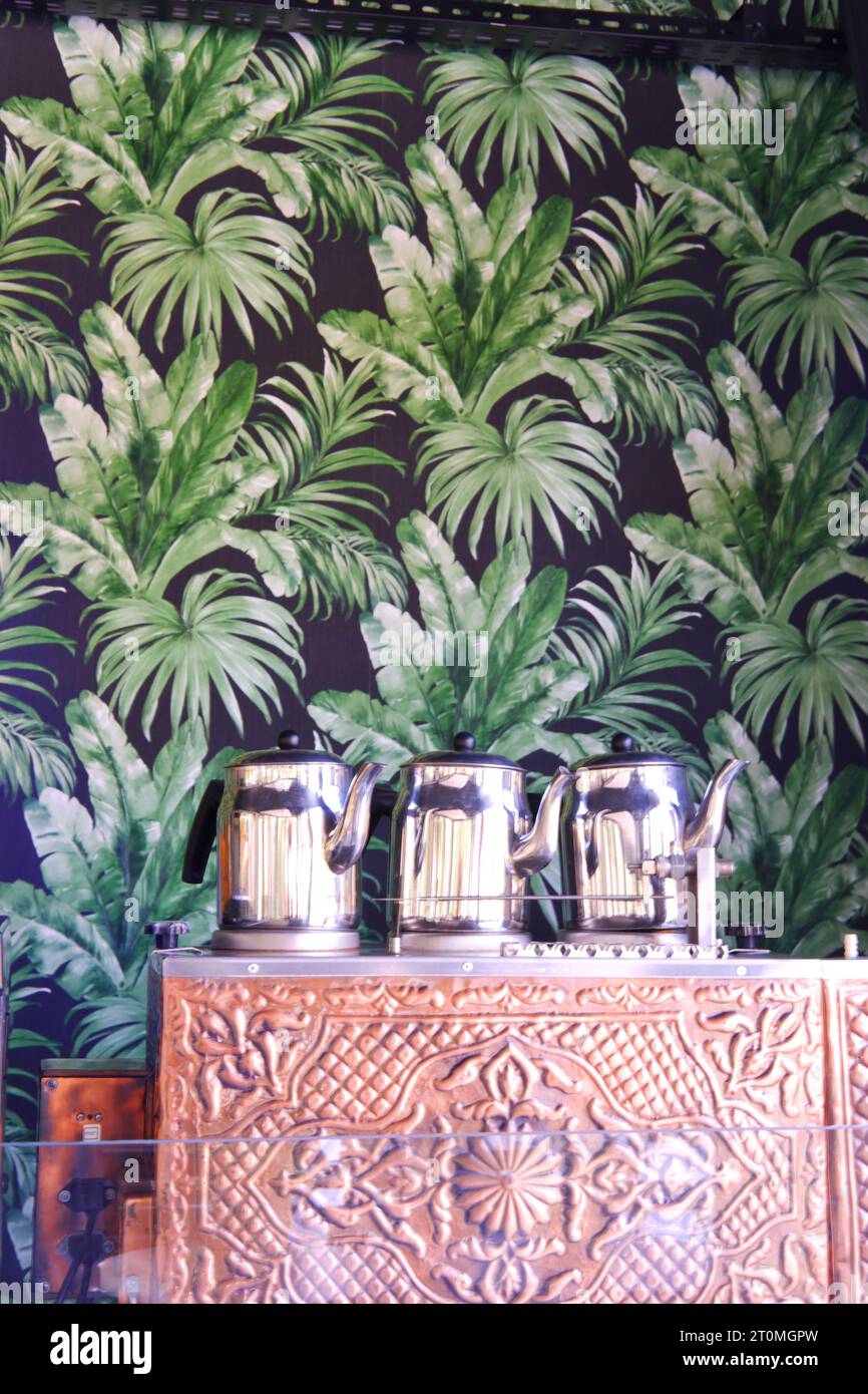 Three teapots and copper water tank for tea preparation in a cafe Stock ...