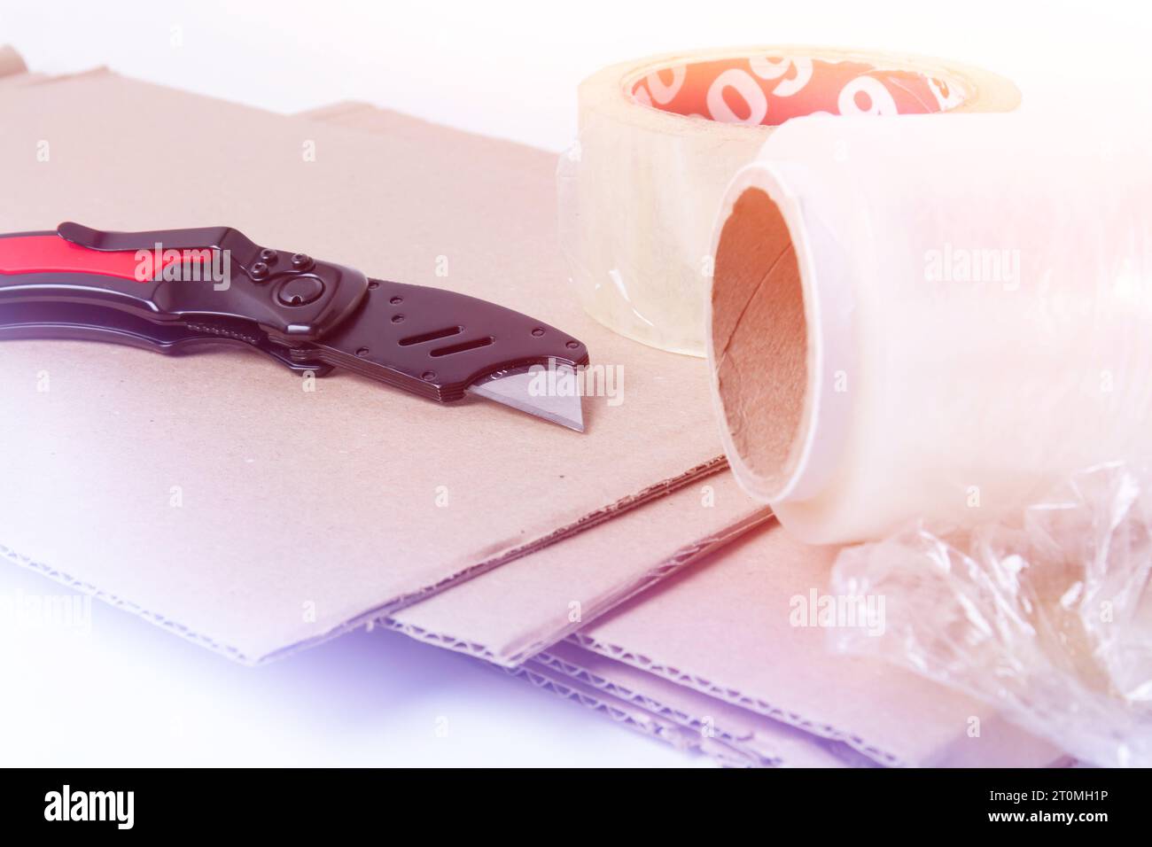 Stretch film and cardboard packaging on a white background top view ...