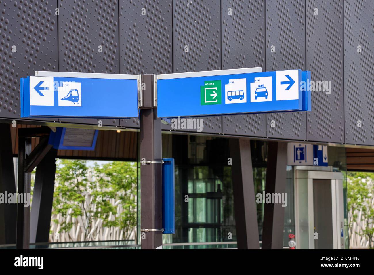 Direction signs on platform between trains and trams on station ...