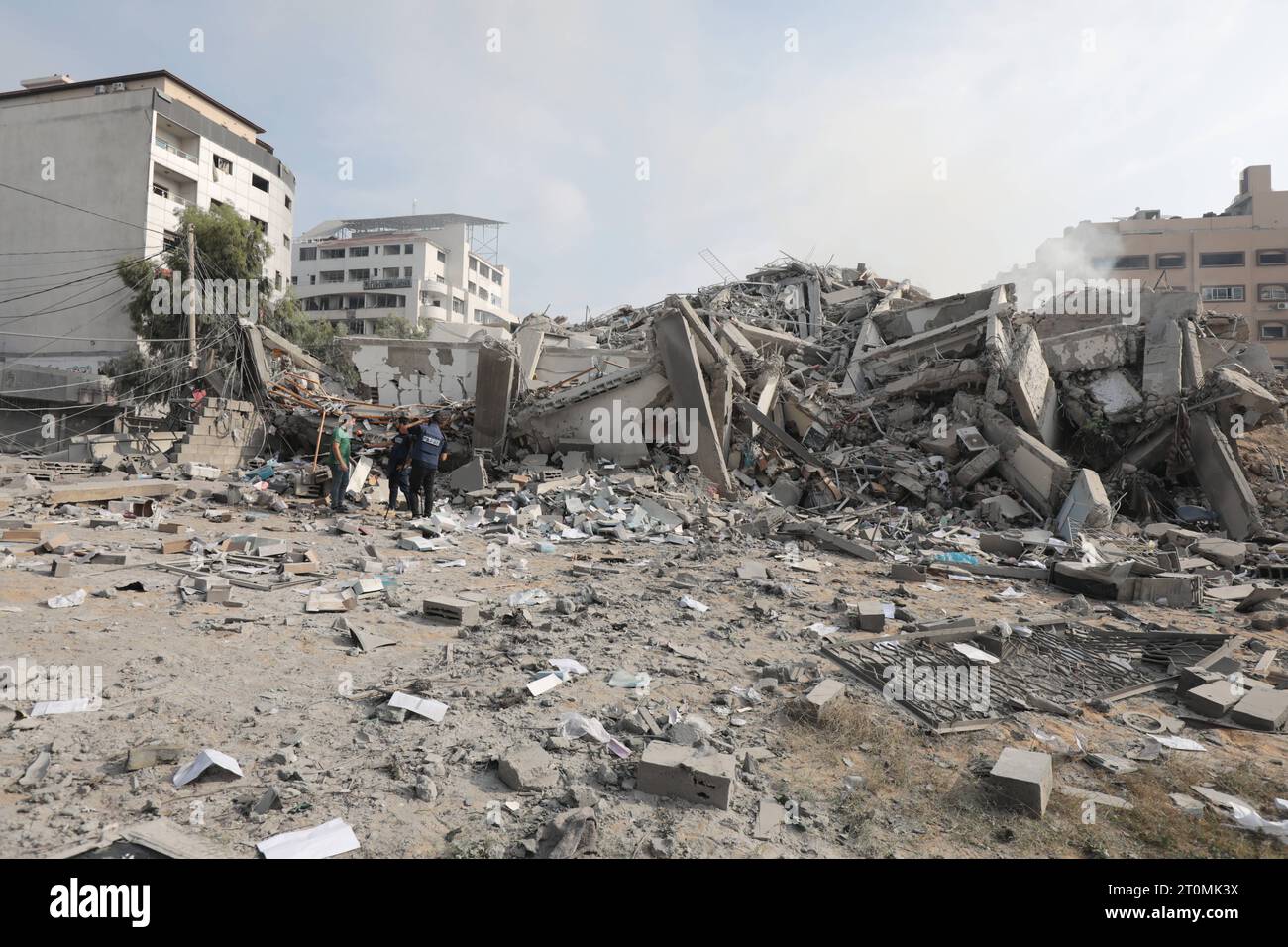 Palestinians inspect the ruins of Watan Tower destroyed in Israeli ...