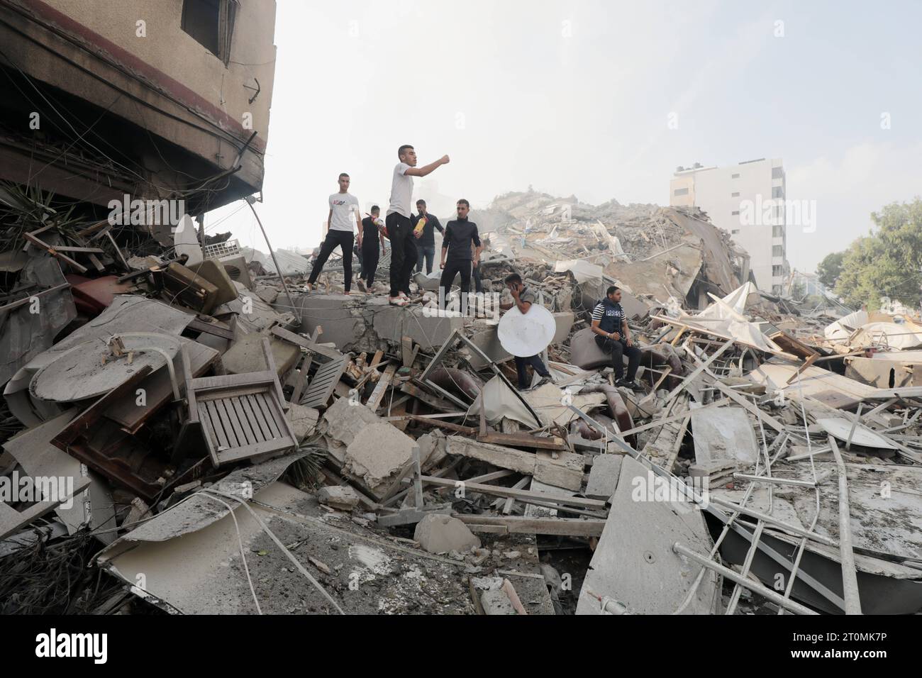 Palestinians inspect the ruins of Watan Tower destroyed in Israeli ...