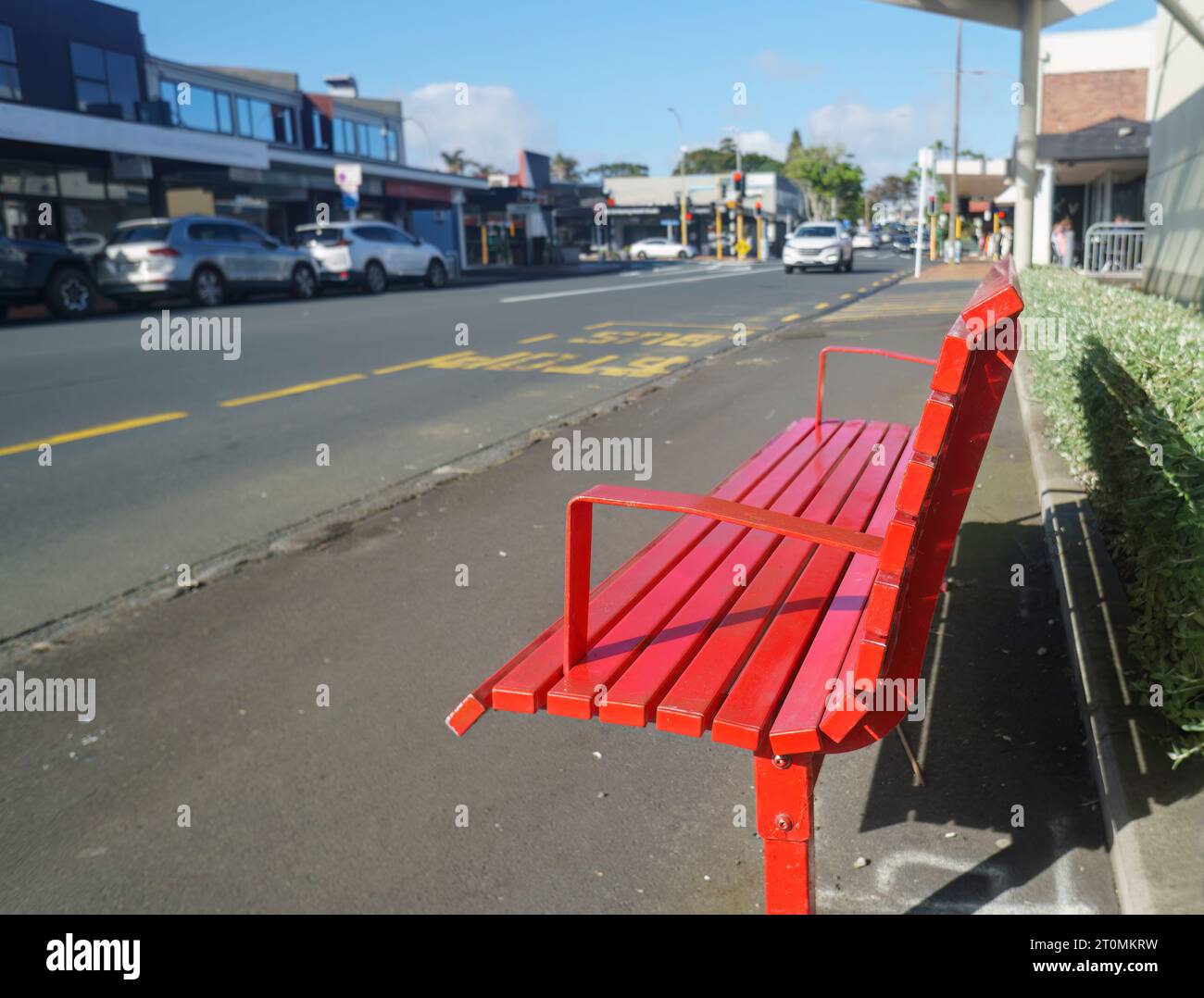 Empty red bench at the bus stop. Auckland Stock Photo - Alamy