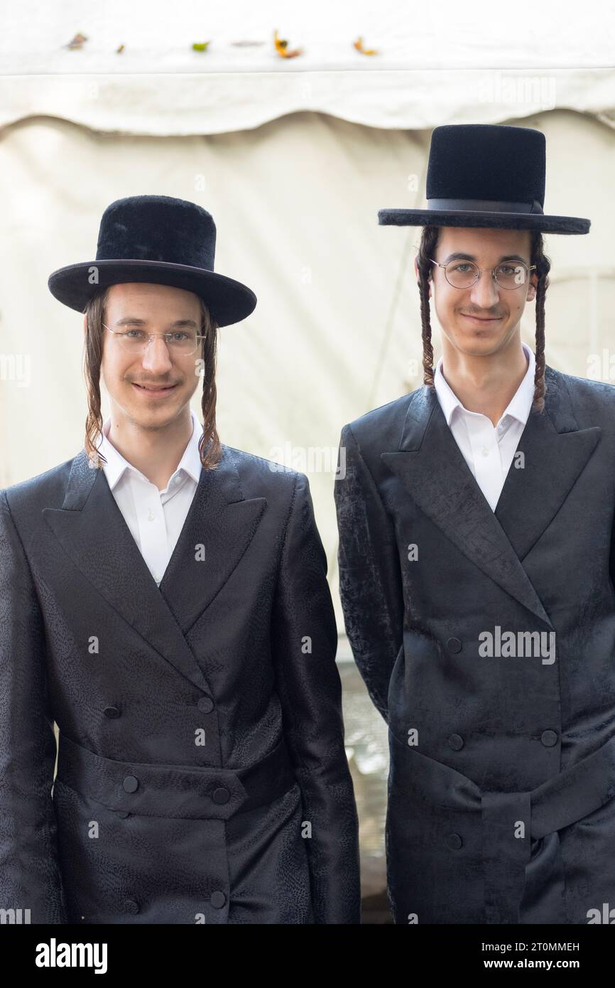 A posed portrait of orthodox Jewish brothers each dressed in black and ...