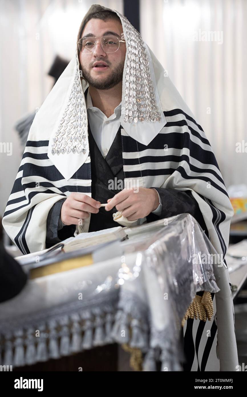 During Sukkos, an orthodox Jewish man prays with fervor at a synagogue ...