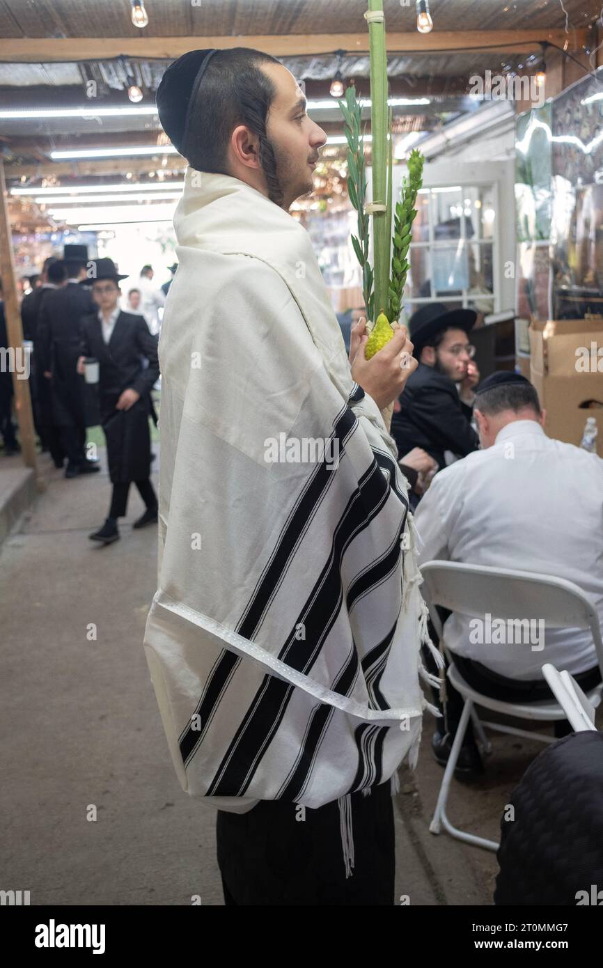 And unidentified orthodox Jewish man wearing a tallis blesses the 4 ...
