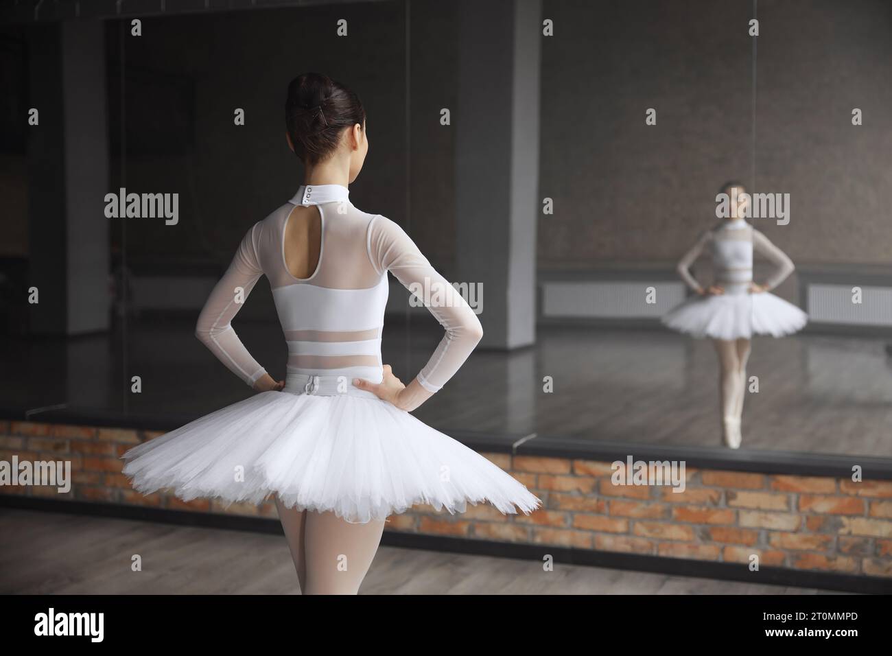 Worried ballerina standing near huge mirror at dance studio Stock Photo - Alamy