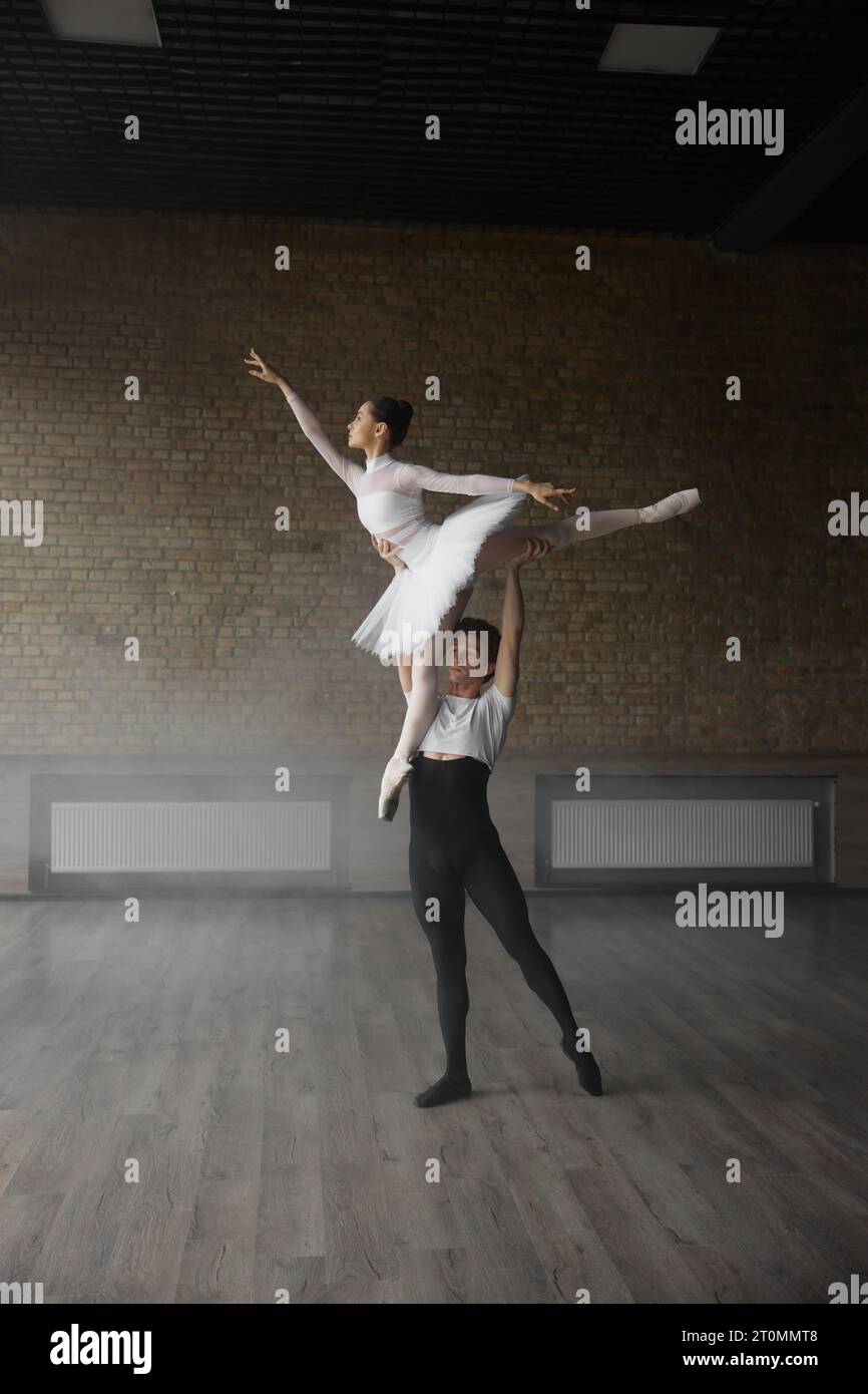 Two young ballet dancers wearing costume practicing together in studio ...