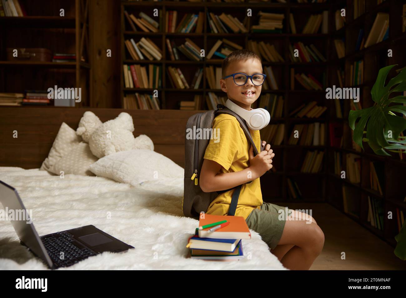 Cute elementary school boy student prepared for offline education Stock ...