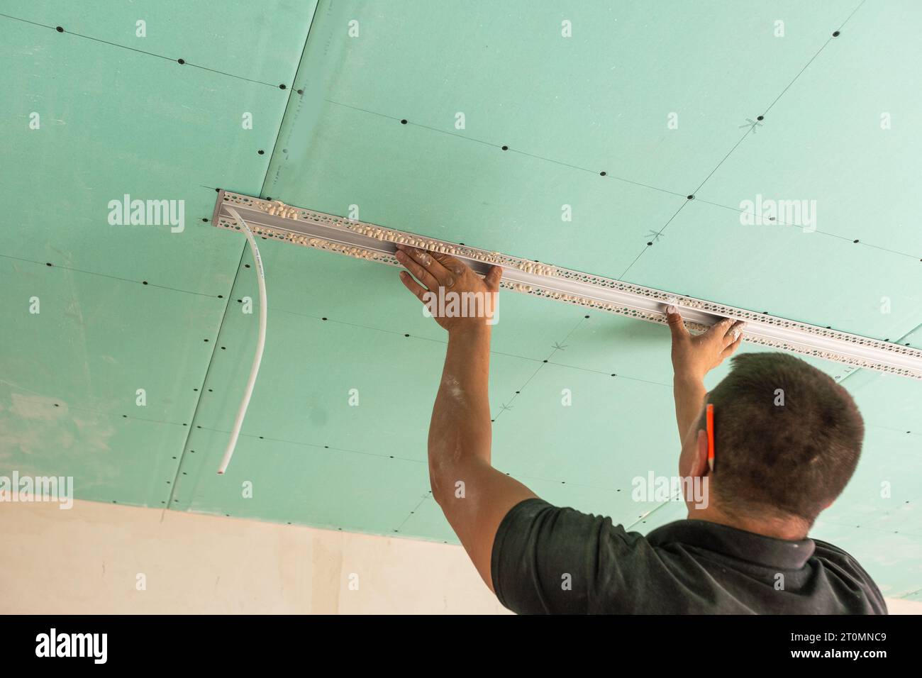 Drywall Installers. Men holding a gypsum board figured cut Stock Photo ...