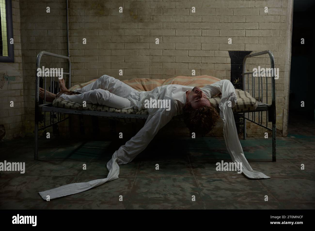 Crazy man tied to bed with belts lies exhausted after madness attack ...