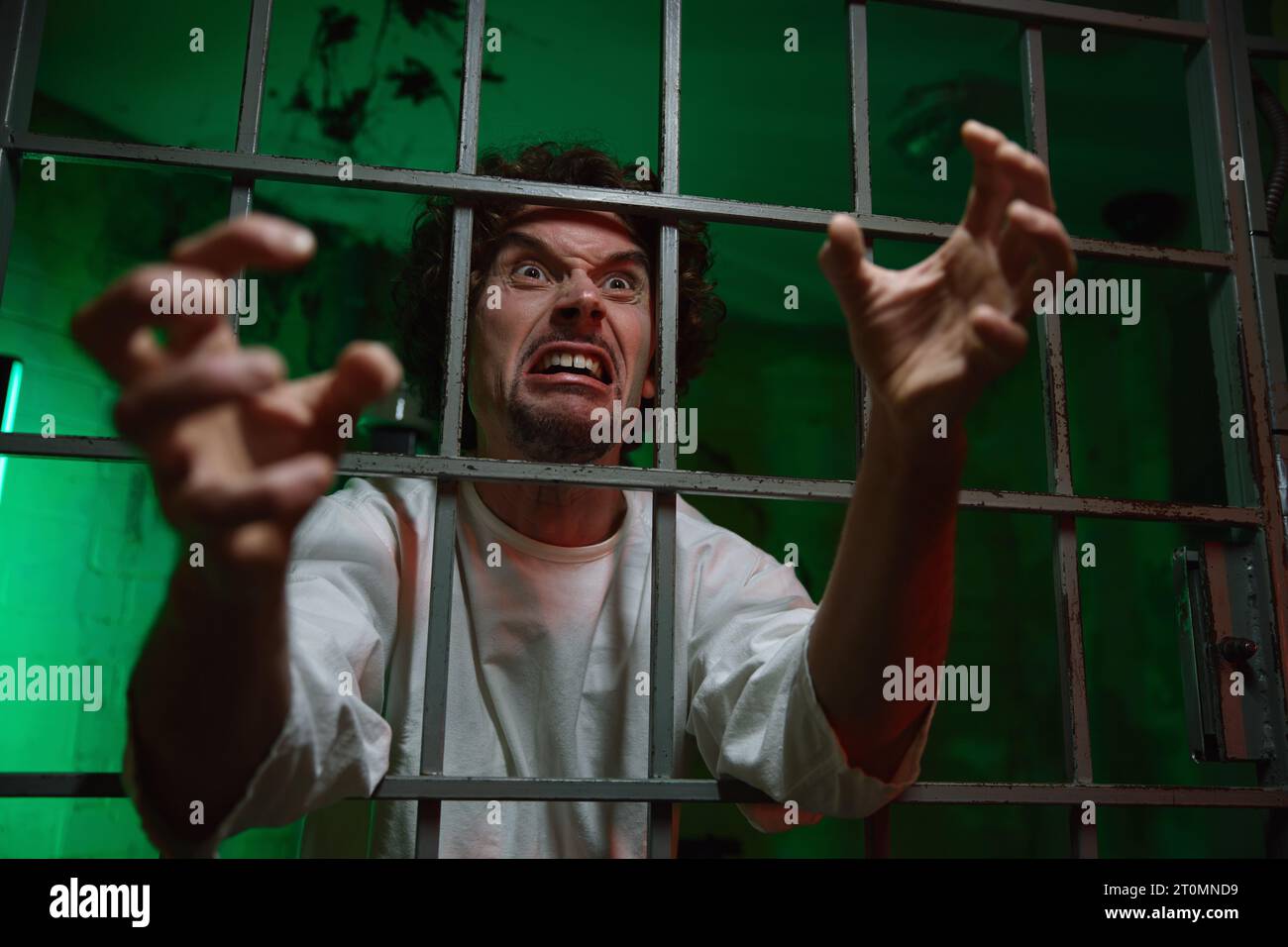 Mentally unstable male patient with attack of rabies locked in cage ...