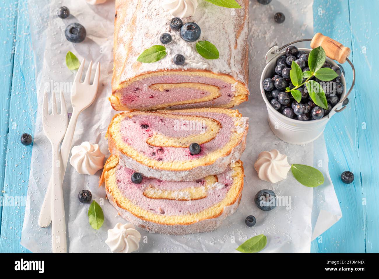 Homemade blueberry swiss roulade made of berry fruits. Mango swiss roll ...