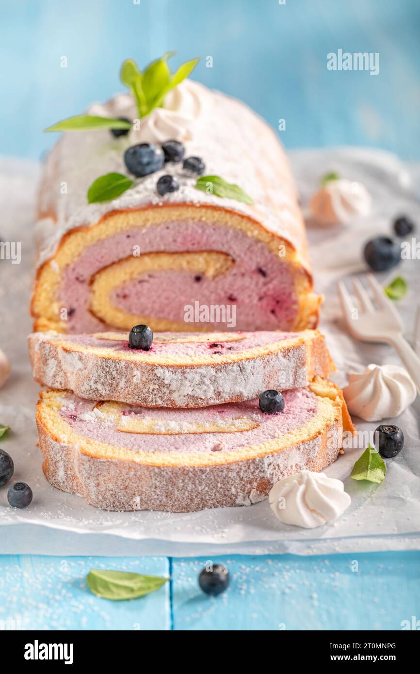 Homemade blueberry swiss roulade with powdered sugar and fruits. Swiss ...