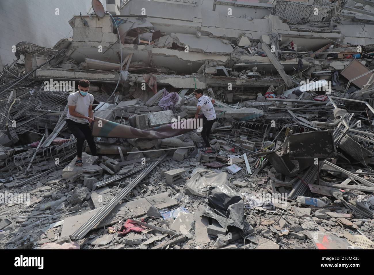 Gaza City, Palestibe. 8th Oct 2023. Palestinians inspect the ruins of ...