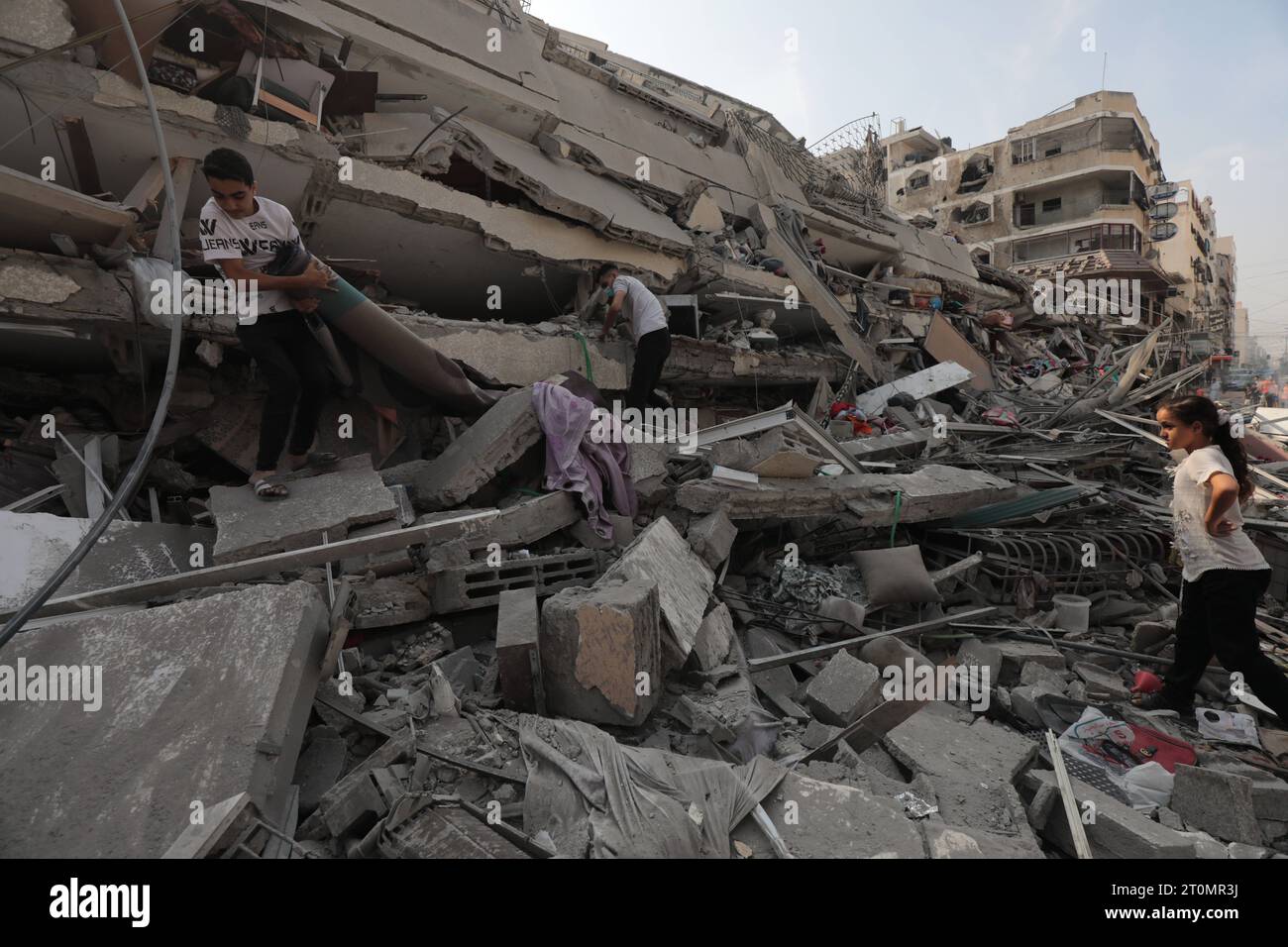 Gaza City, Palestibe. 8th Oct 2023. Palestinians inspect the ruins of ...