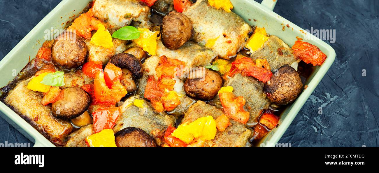 Roasted hake fish with orange, tomato and mushrooms Stock Photo - Alamy