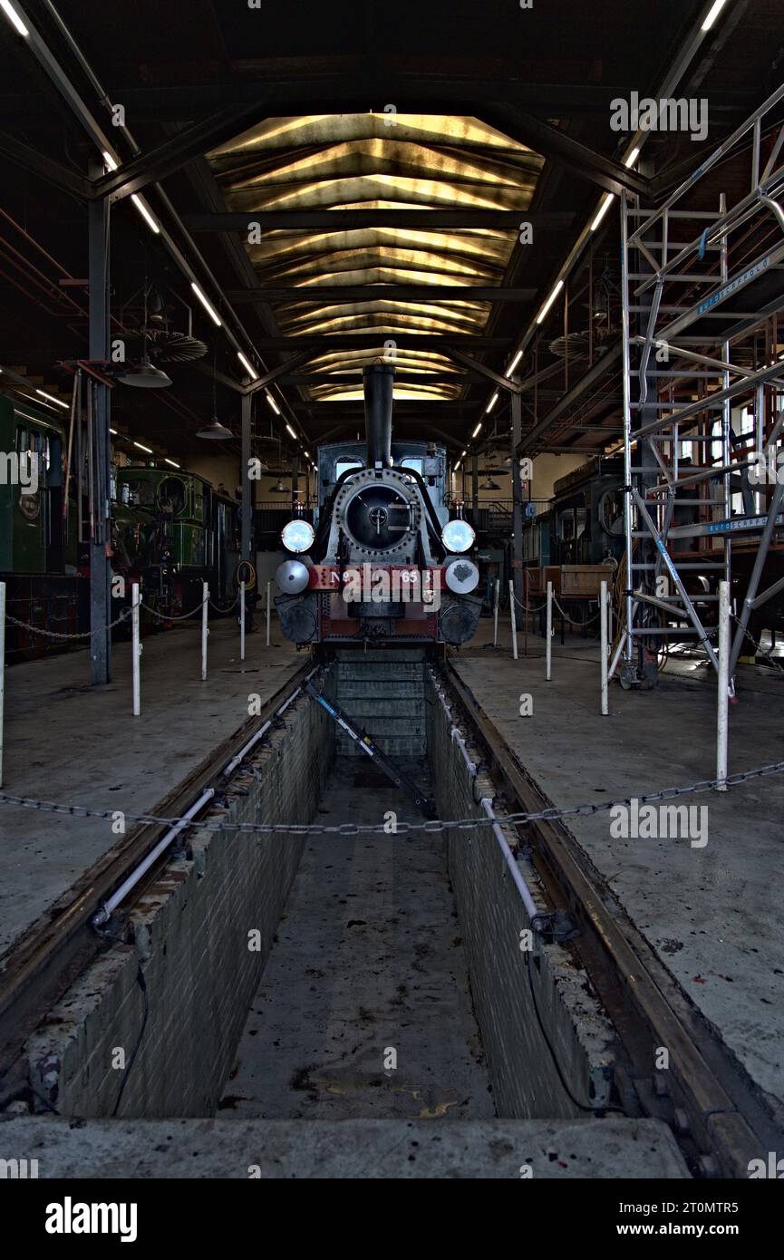 Front view of an old steam locomotive in the depot for maintenance in a ...