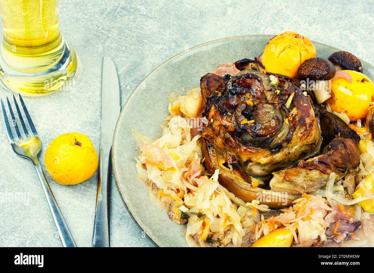 Roasted knuckle of pork with cabbage and beer. Traditional German ...