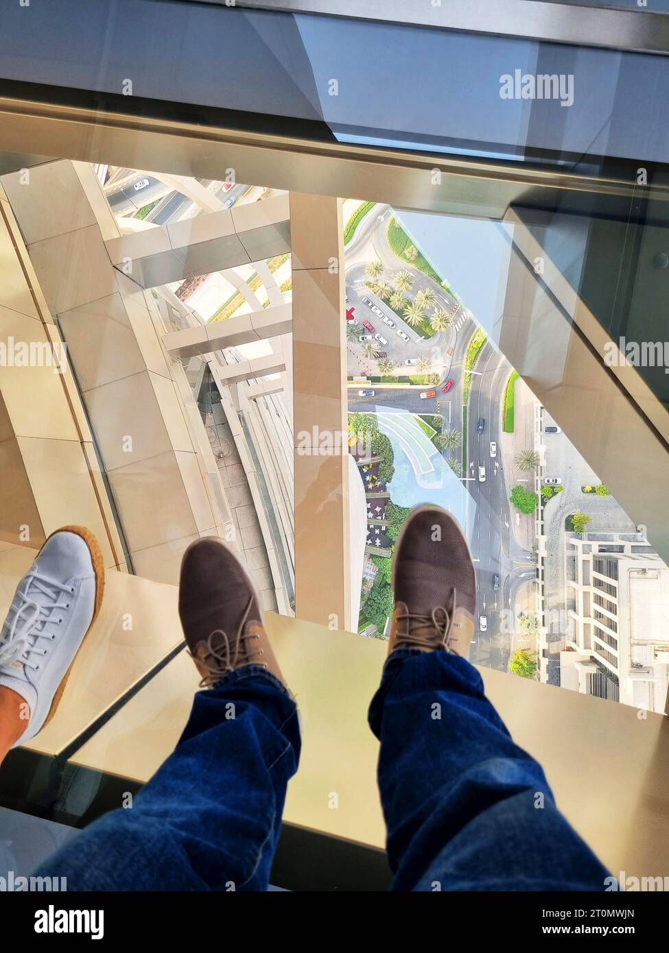 Concept shot of the city street trough the glass floor of the ...
