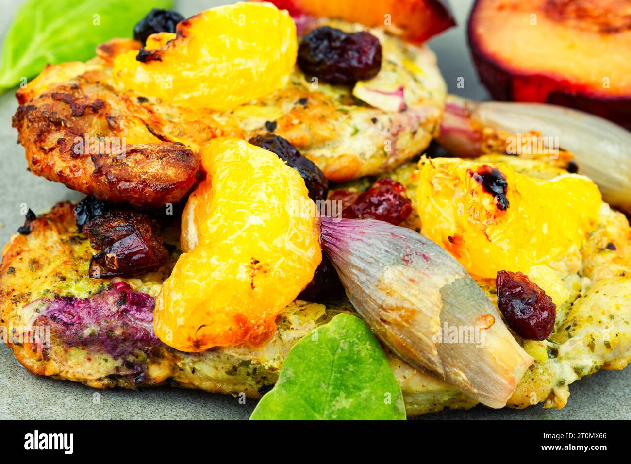 Meat chop cooked with plums and tangerine. Baked delicious meat steak ...