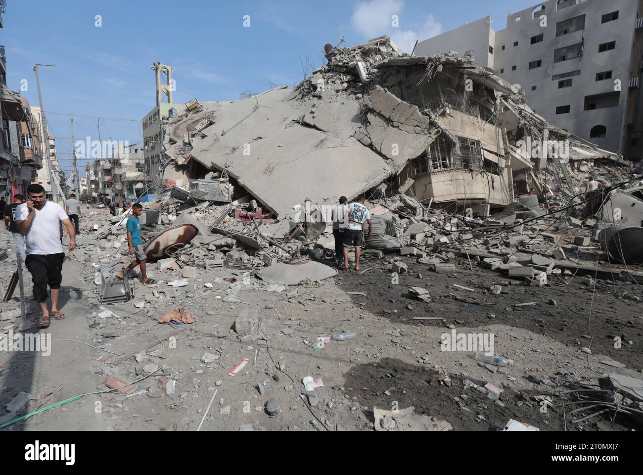 Palestinians inspect the ruins of Aklouk Tower destroyed in Israeli ...