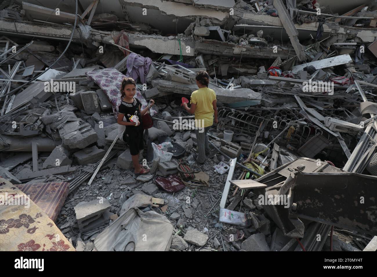 Palestinians inspect the ruins of Aklouk Tower destroyed in Israeli ...
