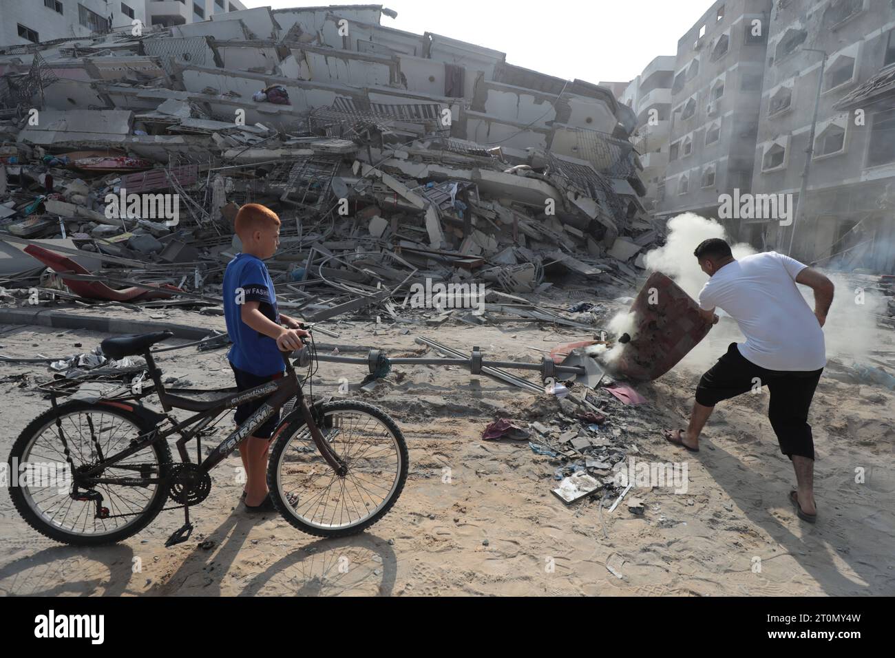 Palestinians inspect the ruins of Aklouk Tower destroyed in Israeli ...