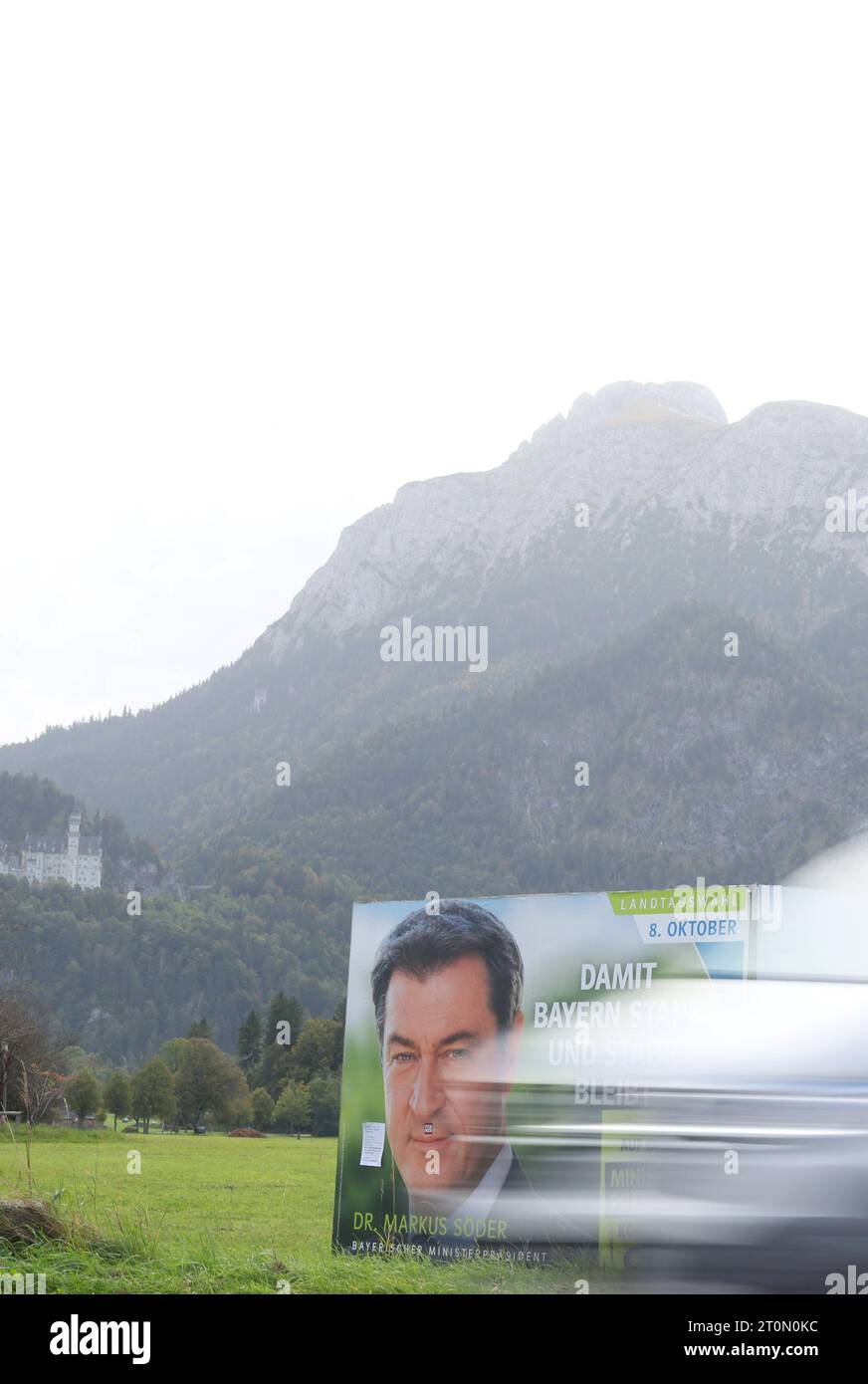 Schwangau, Germany. 08th Oct, 2023. A car drives past a CSU election ...