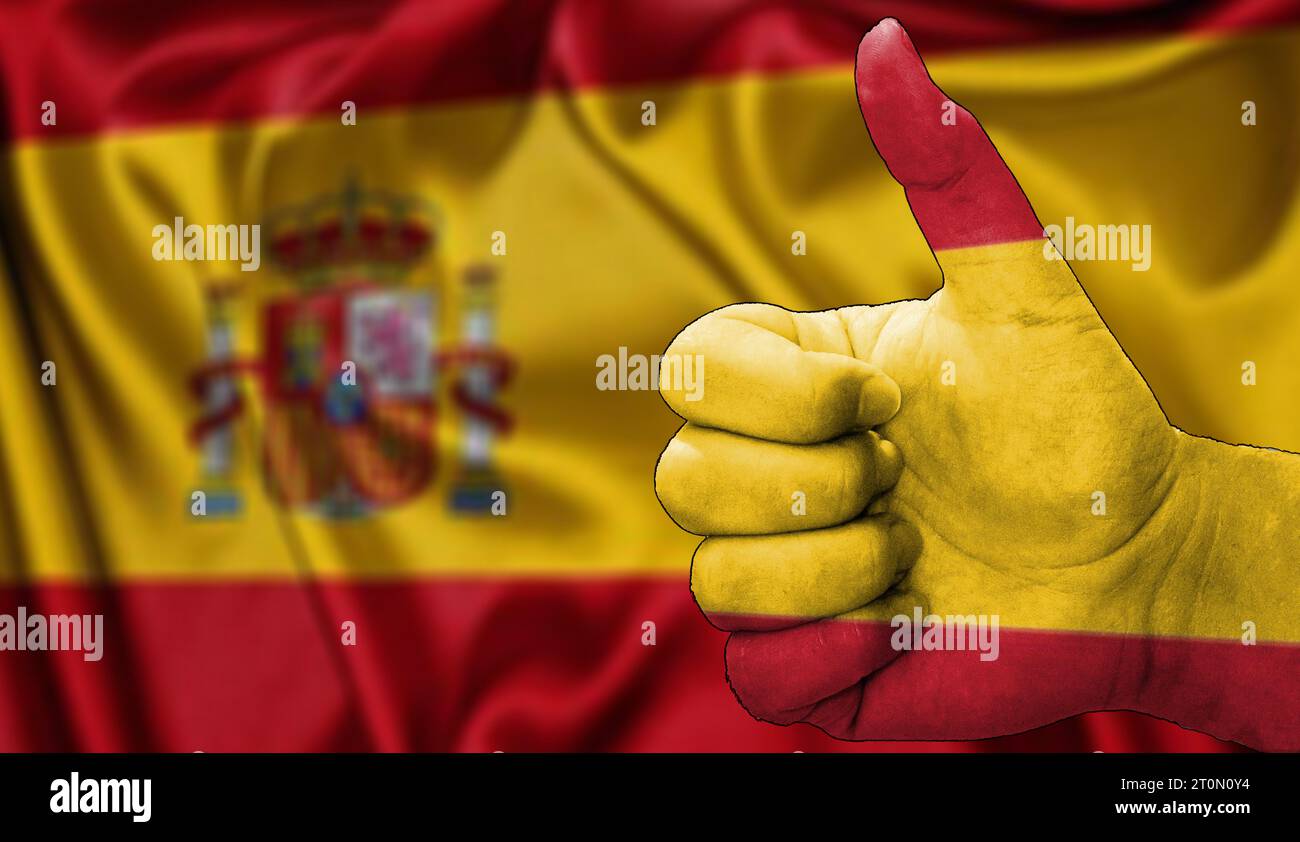 thumbs up in approval with the Spanish flag painted Stock Photo - Alamy
