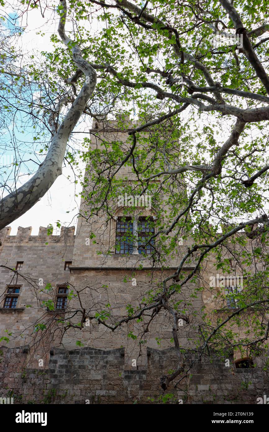 Tall tower façade of the fortifications of Rhodes medieval city behind ...
