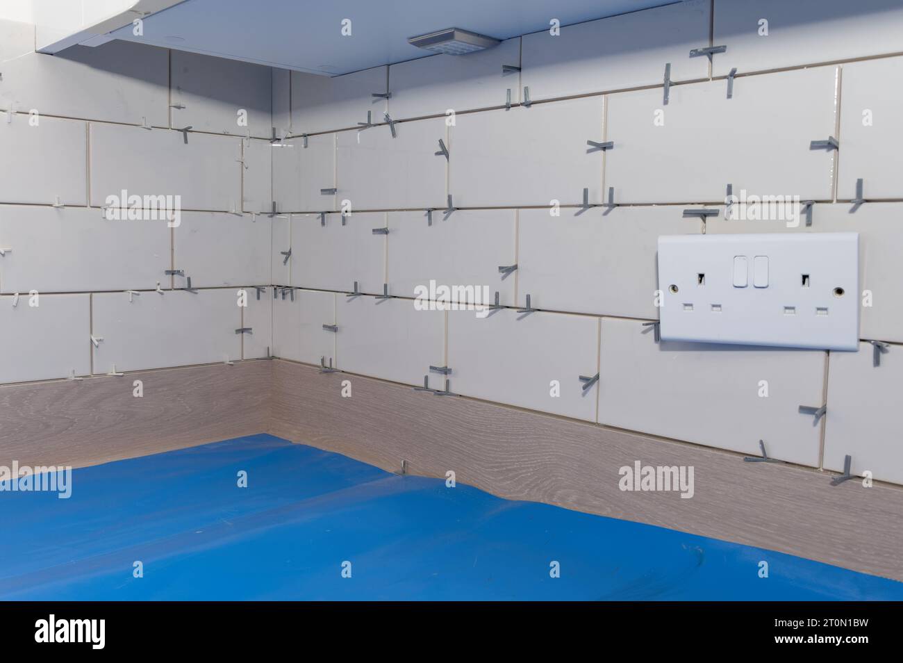 New tile installation in kitchen with electrical sockets removed Stock ...