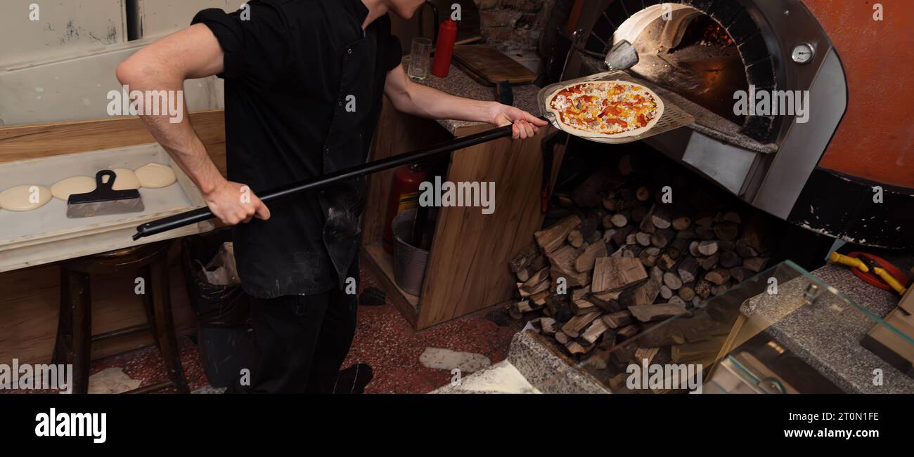 Preparing traditional italian pizza in a professional oven with open ...