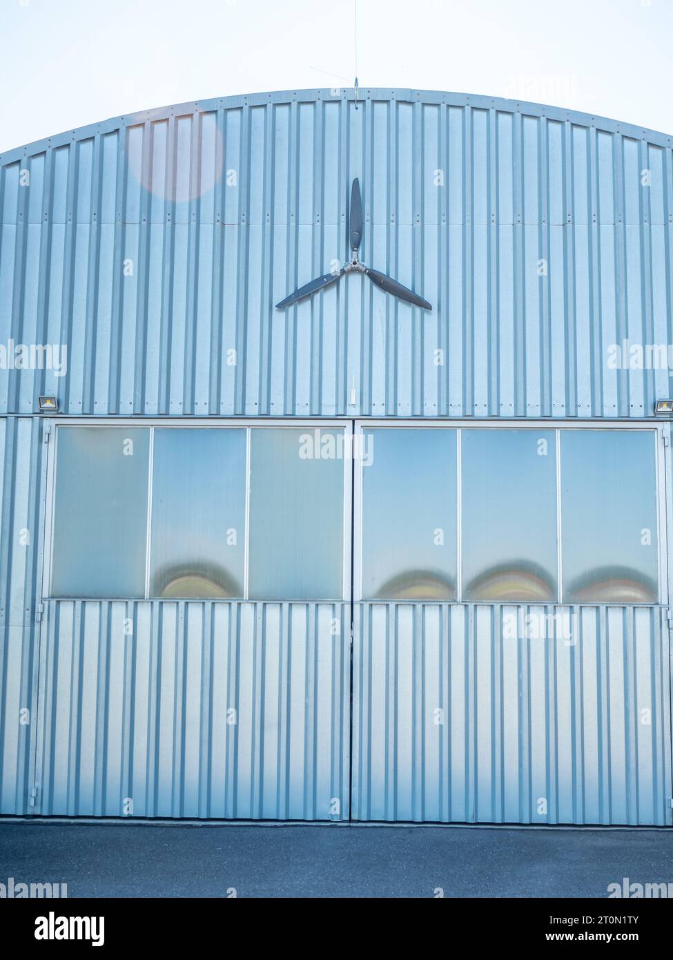 Old carbon propellers mounted on metal sheet hall wall at airport ...