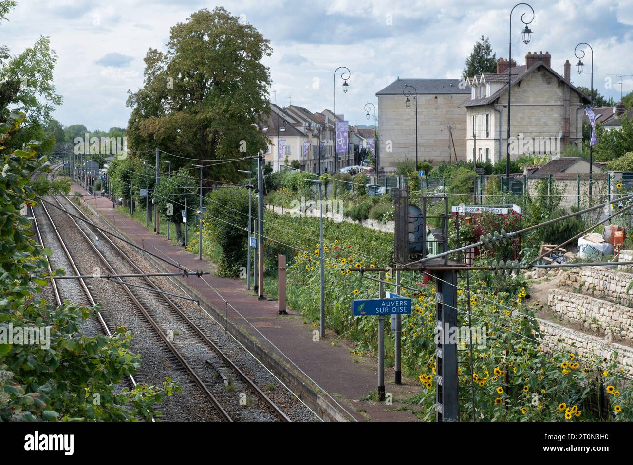 Train tracks and platform at the train station Auvers-sur-Oise is a ...