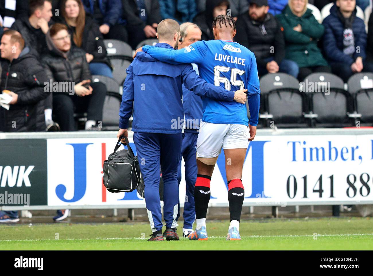 Rangers' Zak Lovelace is helped off the pitch by medical stuff after ...